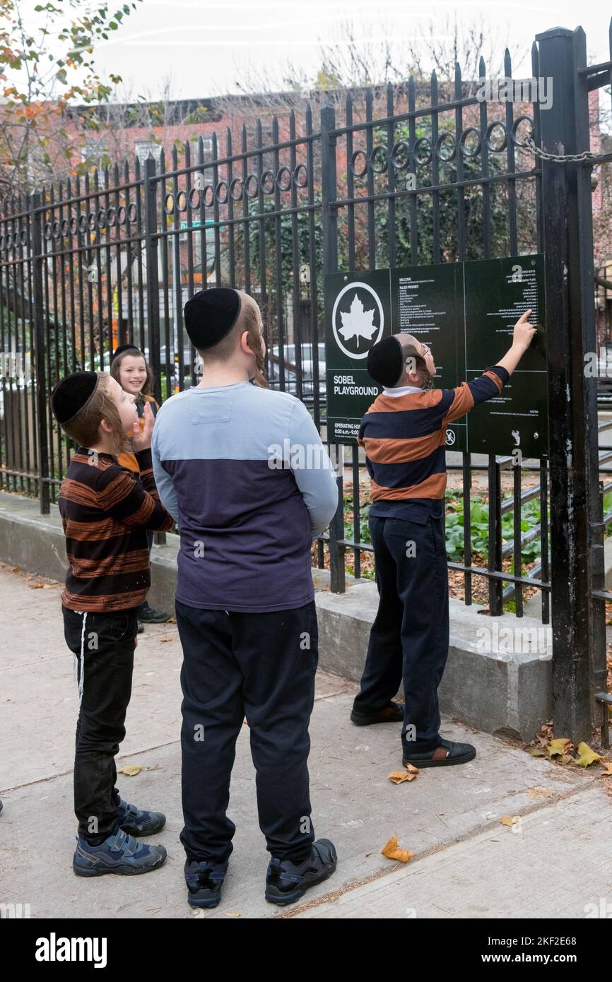 Hasidic Jewish students on recess read a bilingual Yiddish english sign ...