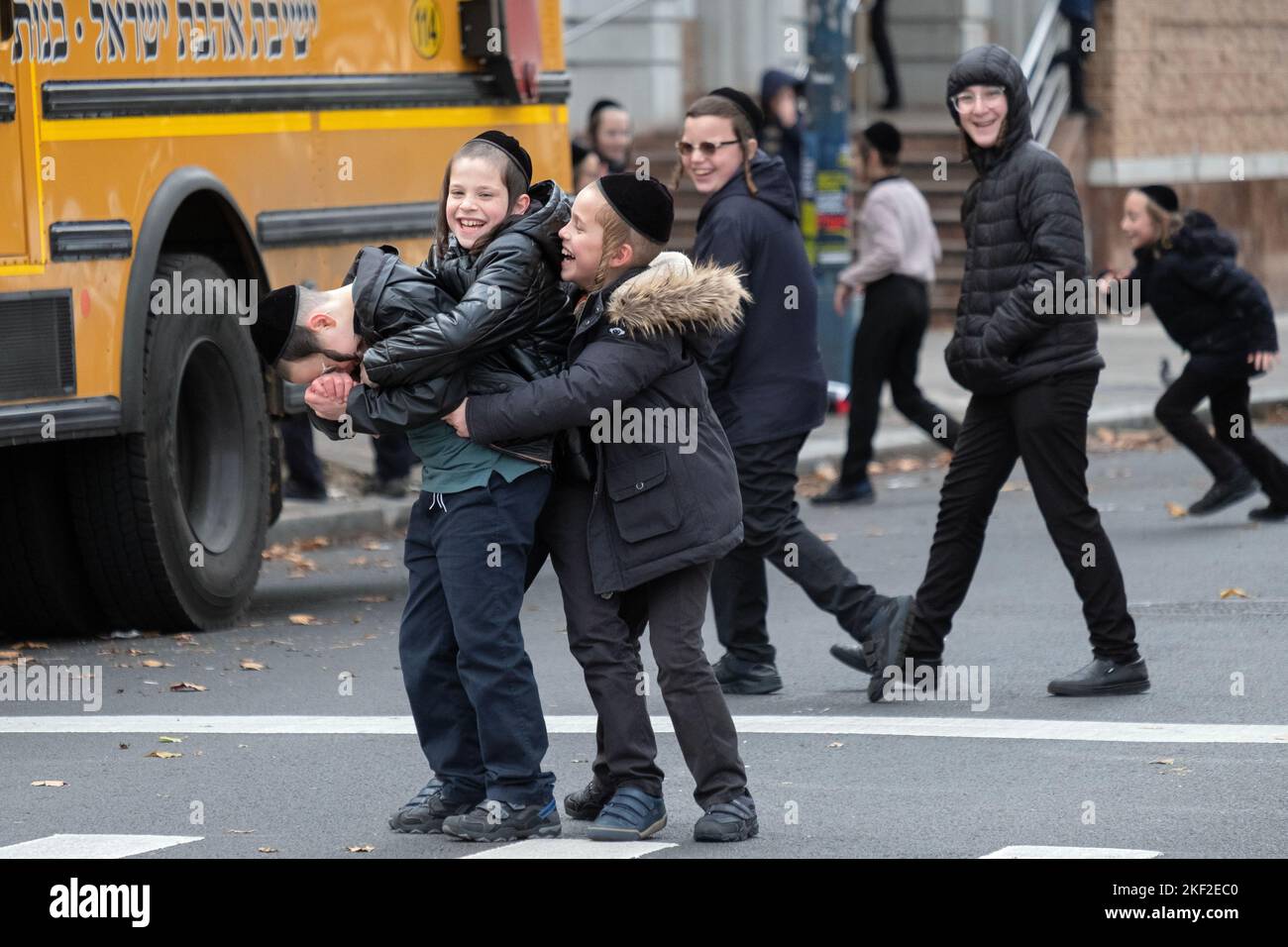 Orthodox Jewish boys with long peyot have fun during recess outside of ...