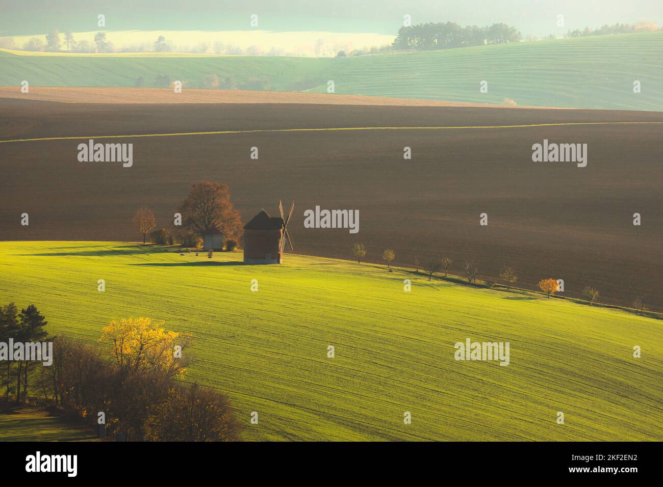 An old fashioned windmill in the agricultural, rural countryside ...