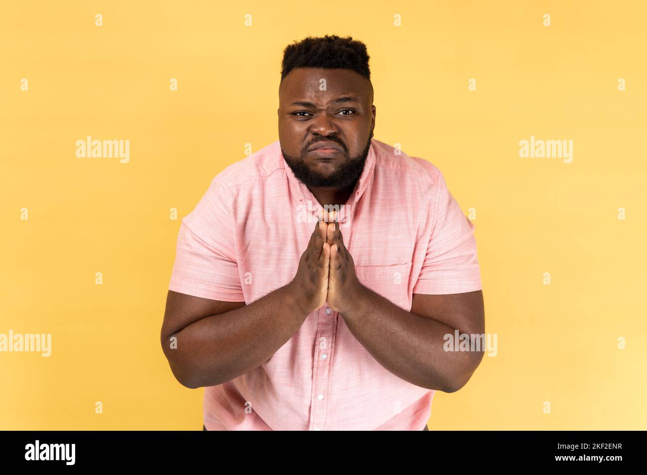 Please, I'm begging forgive. Portrait of upset worried man wearing pink ...