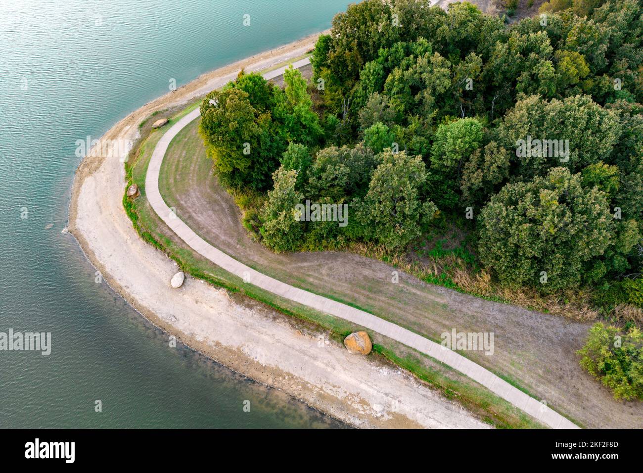 Aerial view of island with green trees and roads surrounded by sea or ...