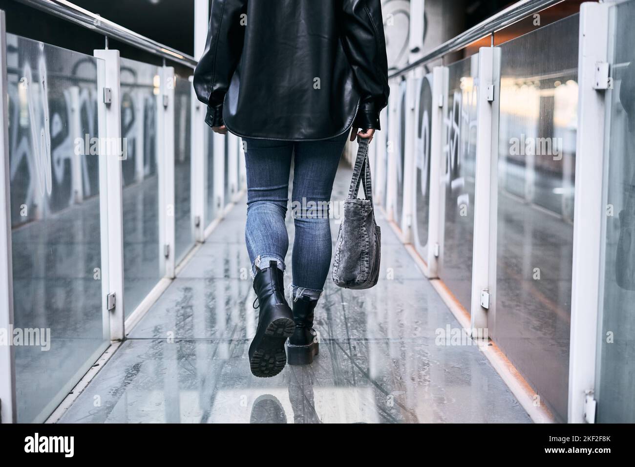back of legs of a latina girl in blue pants fur jacket and big black ...