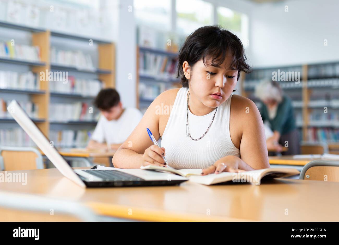 Asian girl with teenagers students studying in school library Stock ...