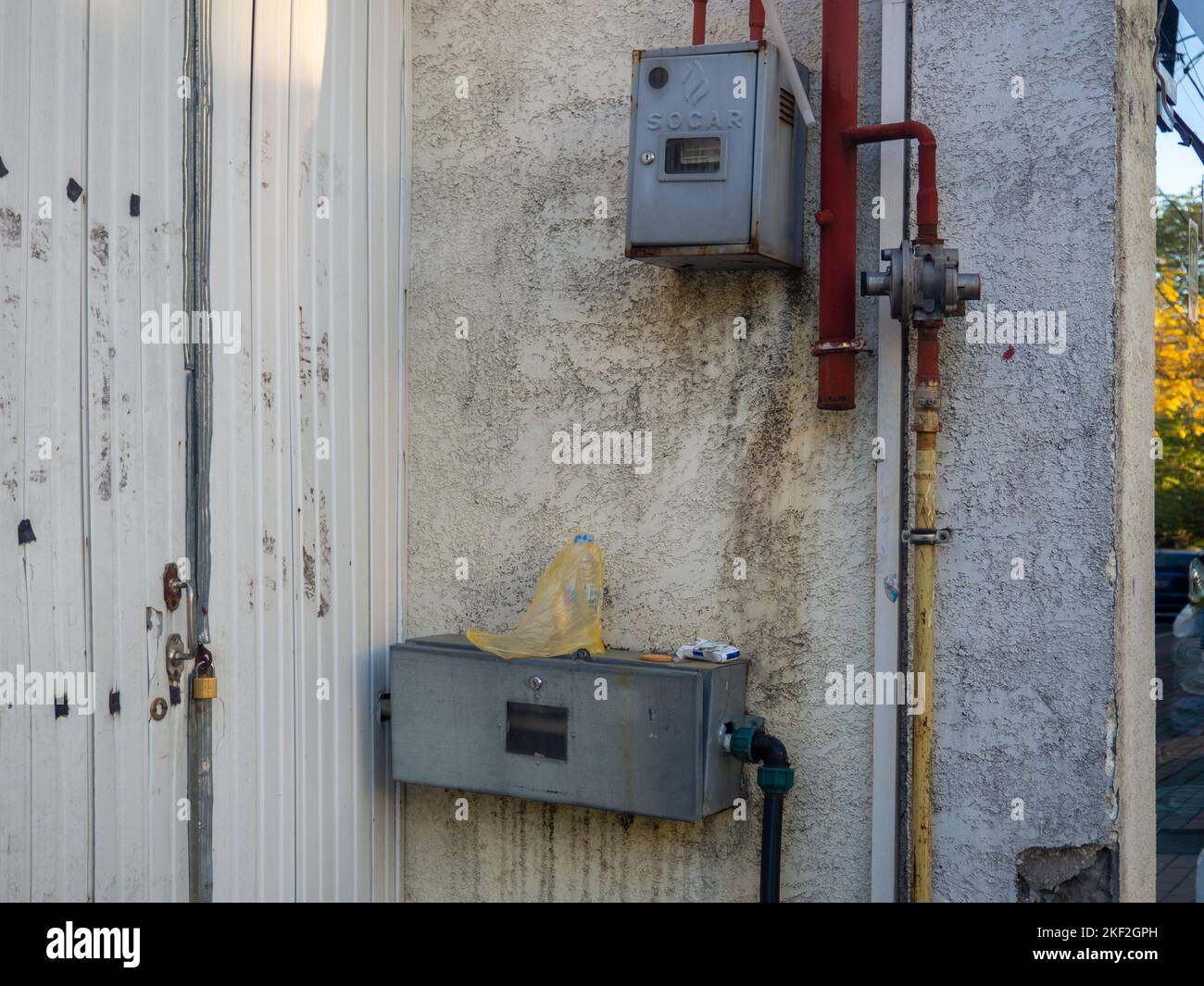 Electricity meters on the wall. Building on the outskirts of the house ...