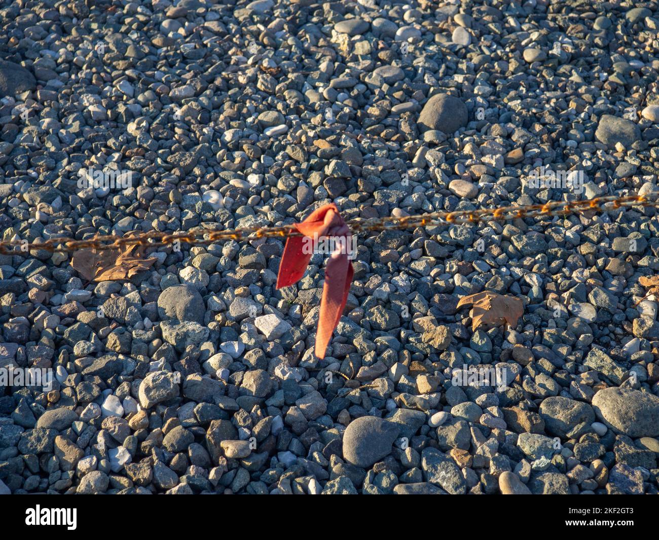 The chain blocking the passage with a red mark. Gray pebble. No way ...
