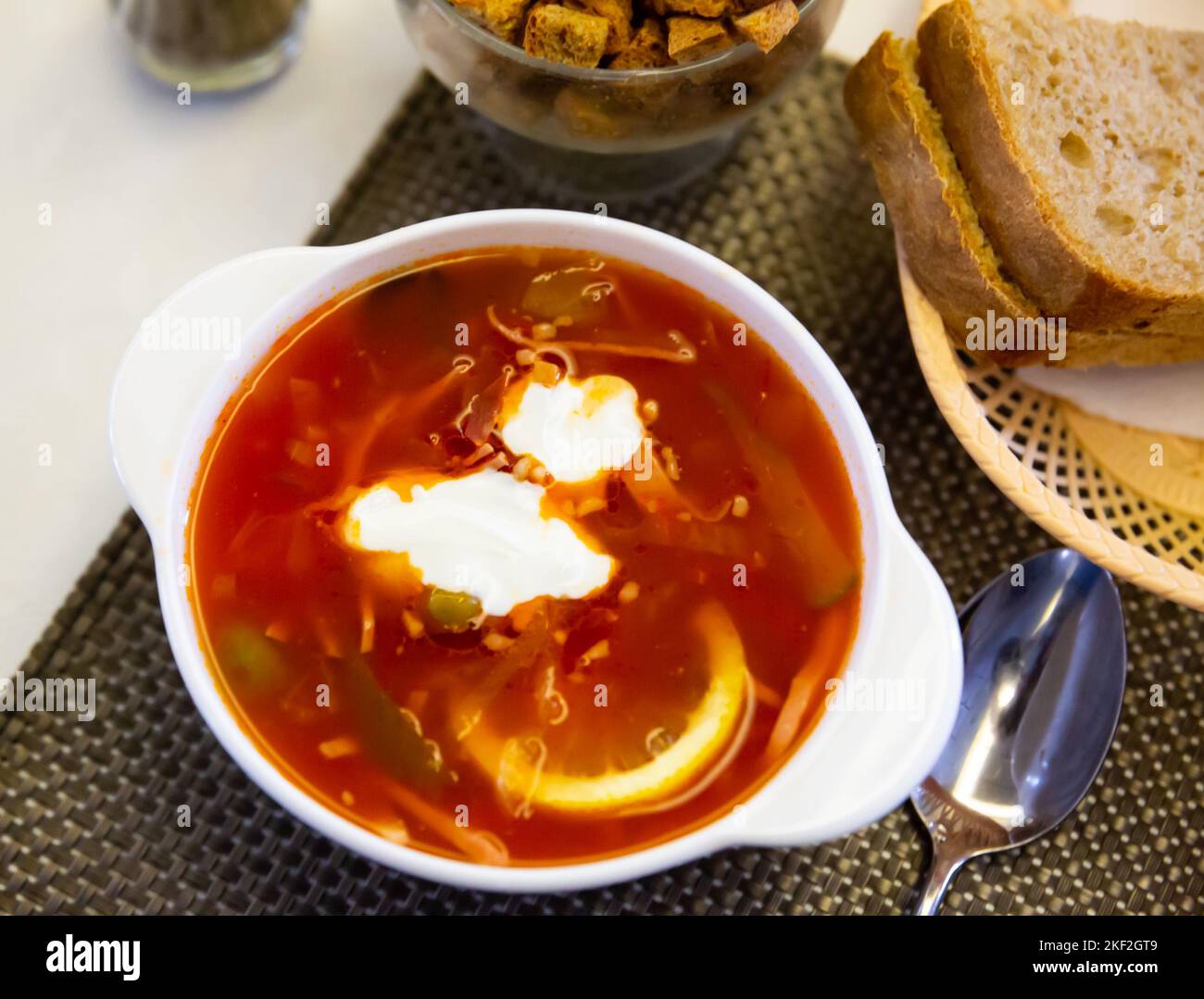 Traditional Russian meat soup Solyanka with sour cream and lemon Stock ...