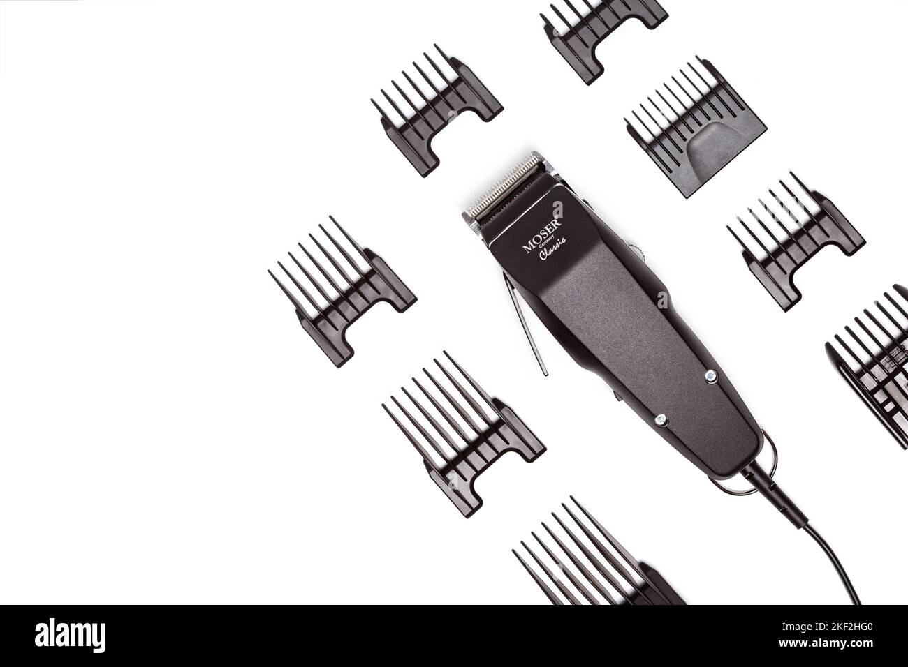 Professional hair clipper with set of nozzles of different sizes ...