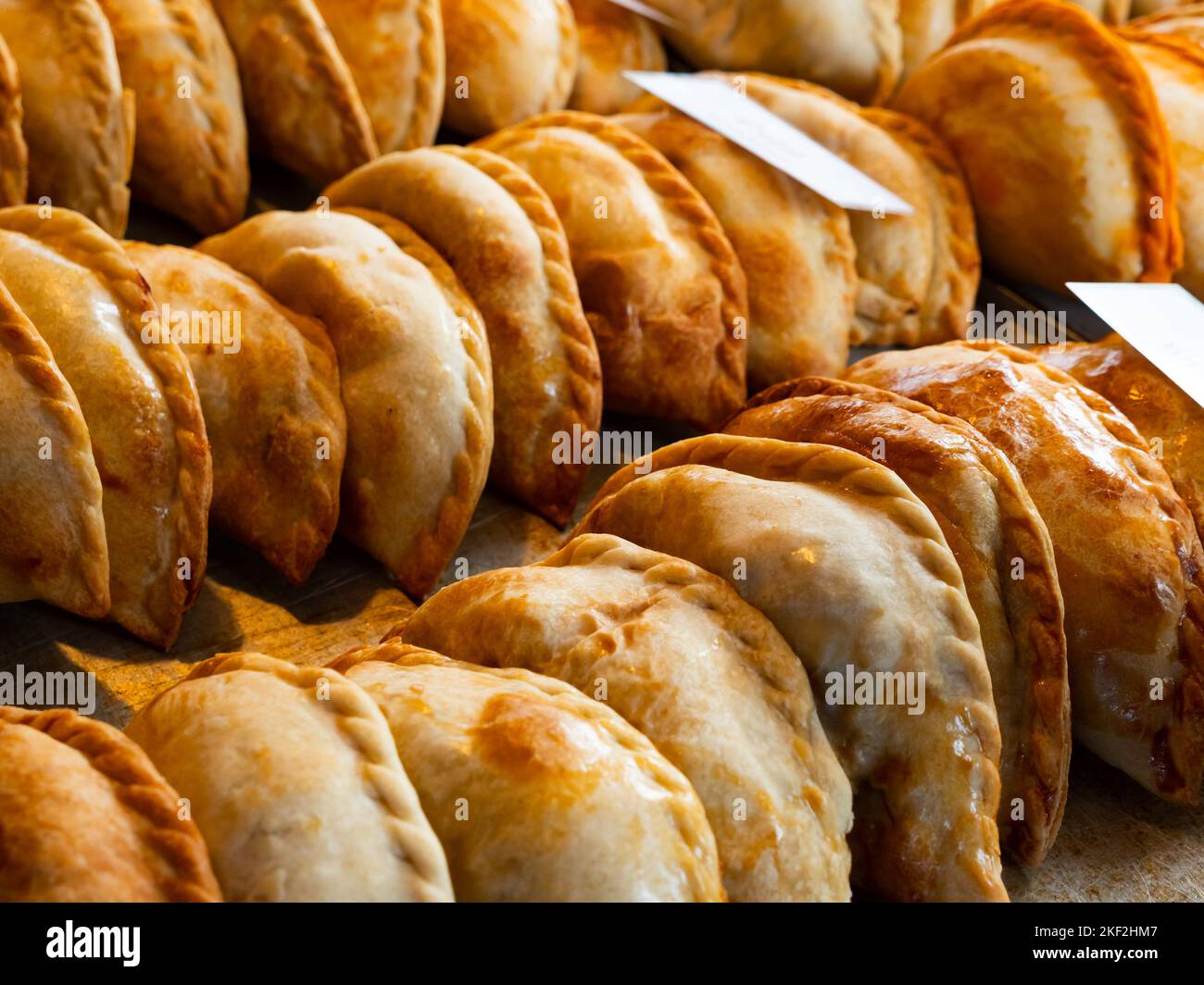 Baked snack empanada at market Stock Photo - Alamy