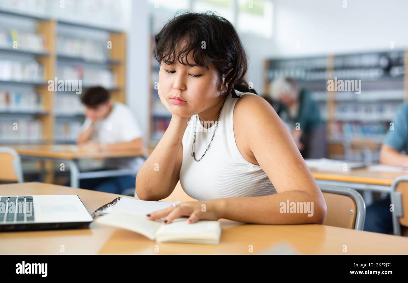 Fifteen-old-year schoolgirl doing homework in the school library Stock ...