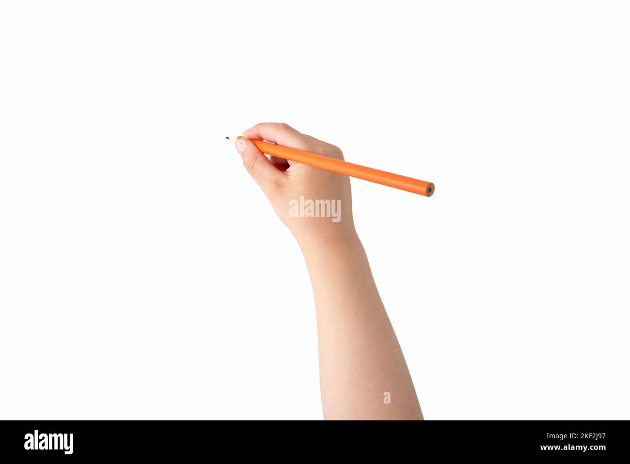 High angle shot of child hand draws a orange pencil with white ...