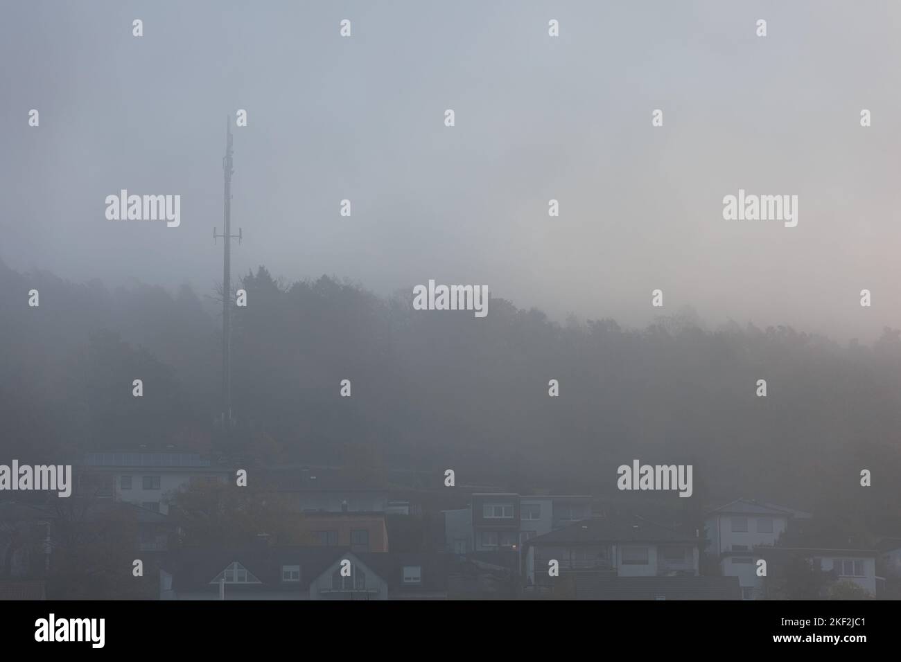 small mountain town shrouded in thick fog Stock Photo - Alamy