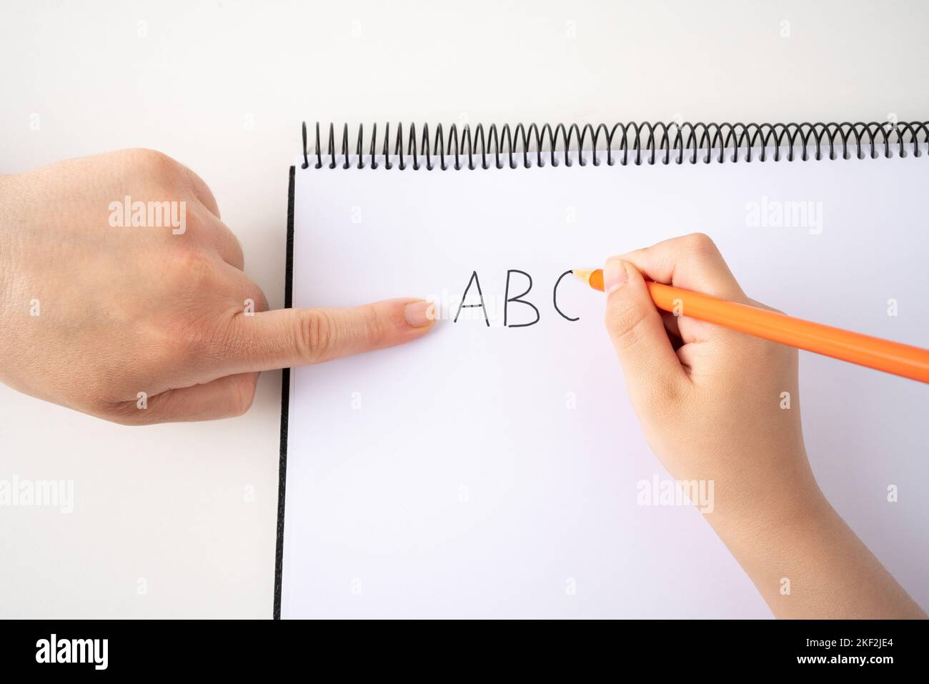 Mom helping elementary age son with school homework. Concept of mother ...