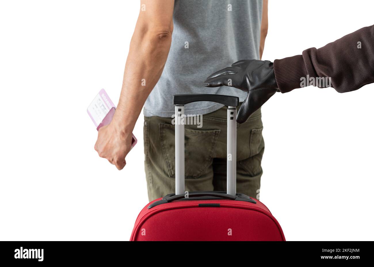 Rear view of a hand of a thief stealing a suitcase in the lobby of ...