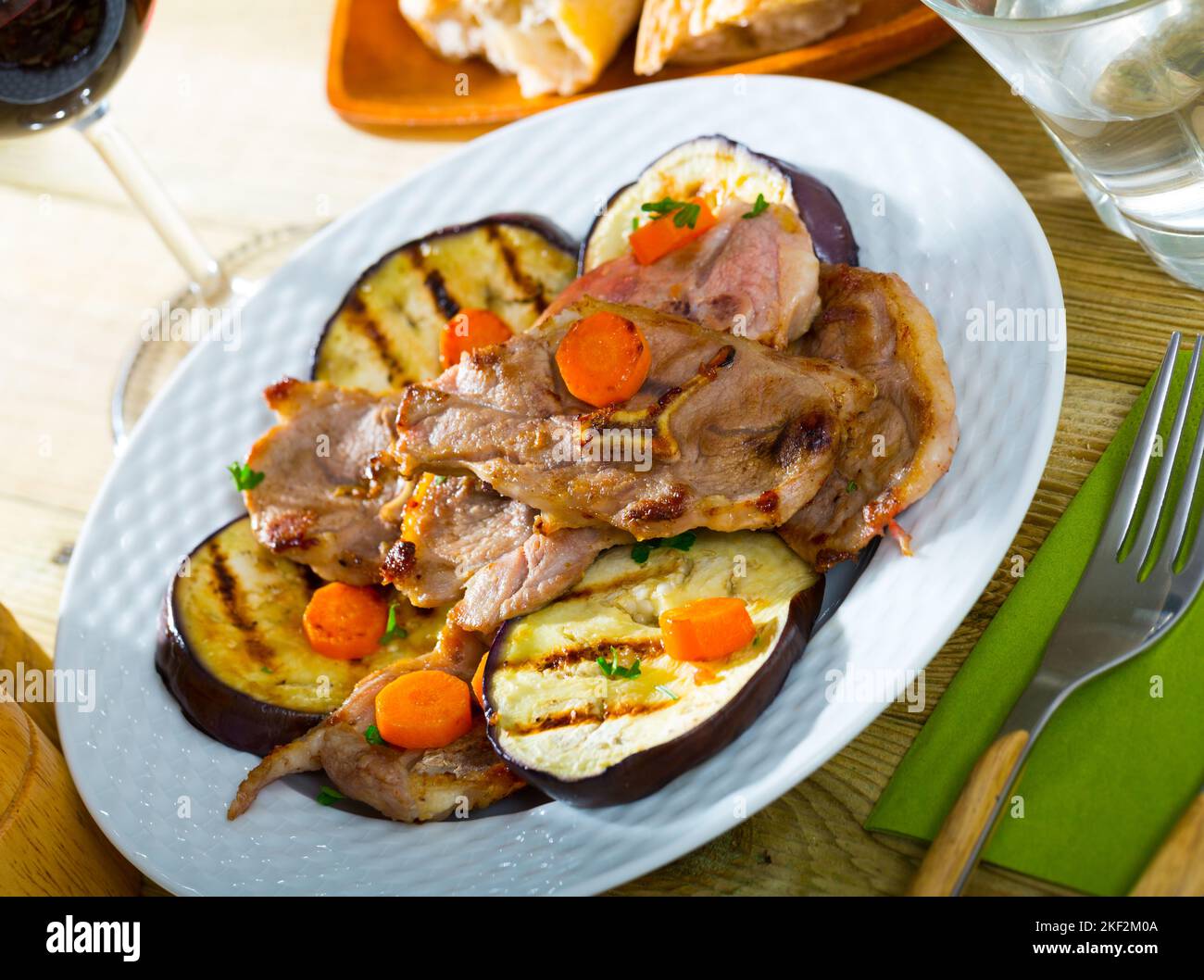 Slices of mutton with grilled eggplant Stock Photo - Alamy