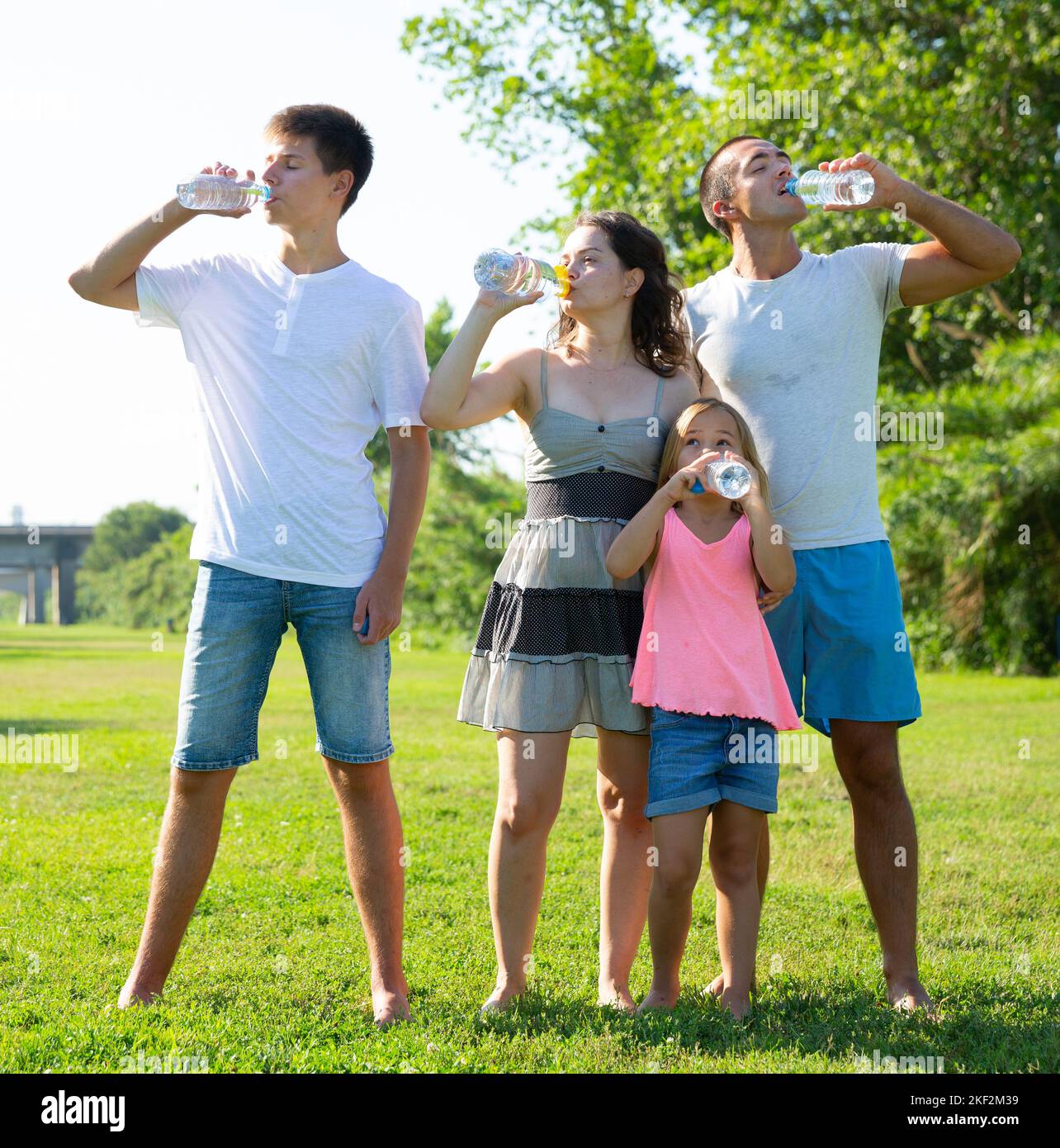 Family drinking water during walk Stock Photo - Alamy