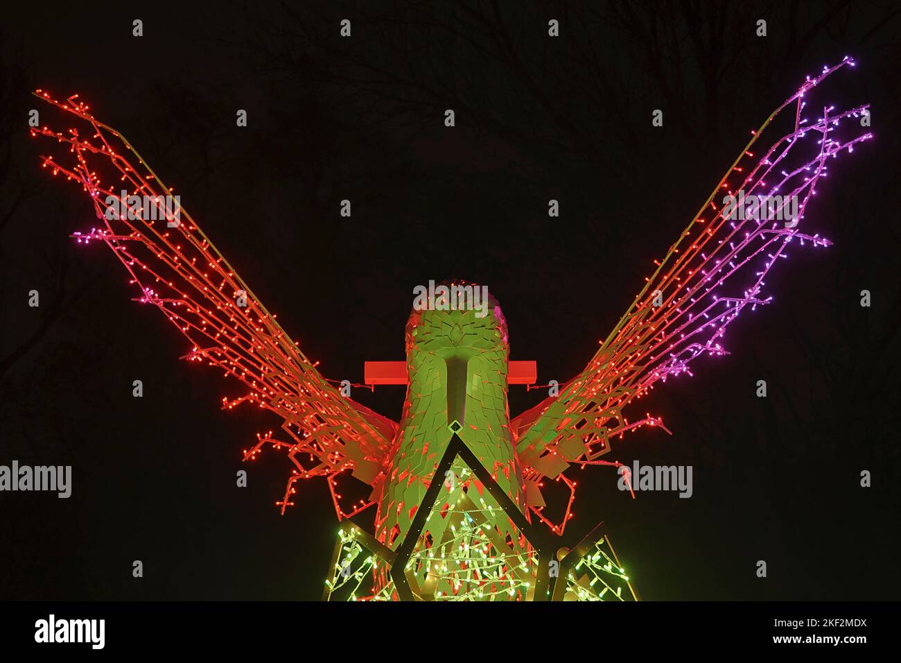 A sculpture with LED colored lights in the shape of a large dove is ...