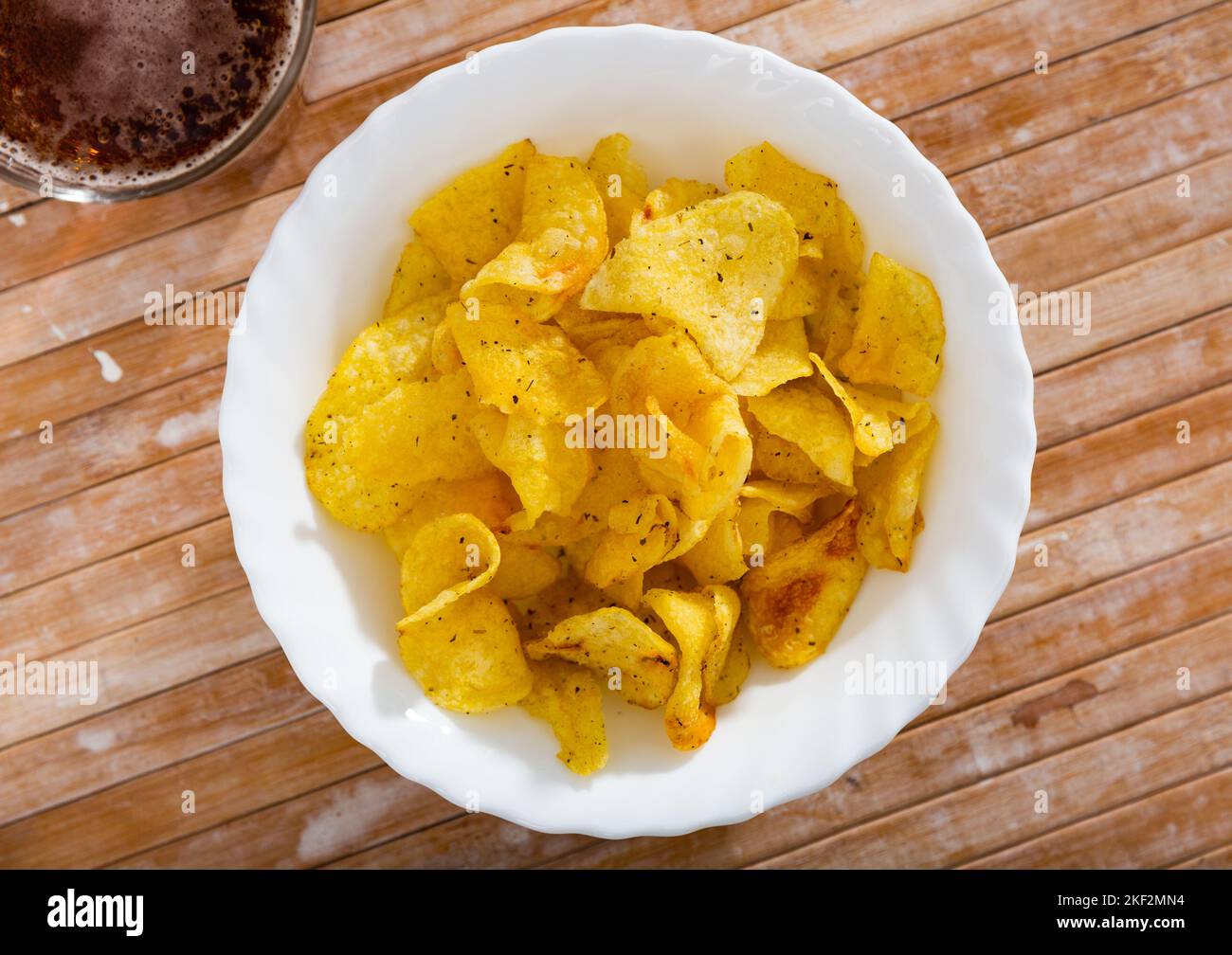Crispy potato chips with glass of cold beer Stock Photo - Alamy