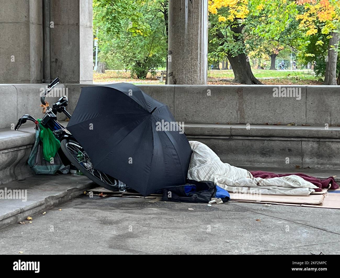 Homeless person camps within a park structure at the entrance of ...