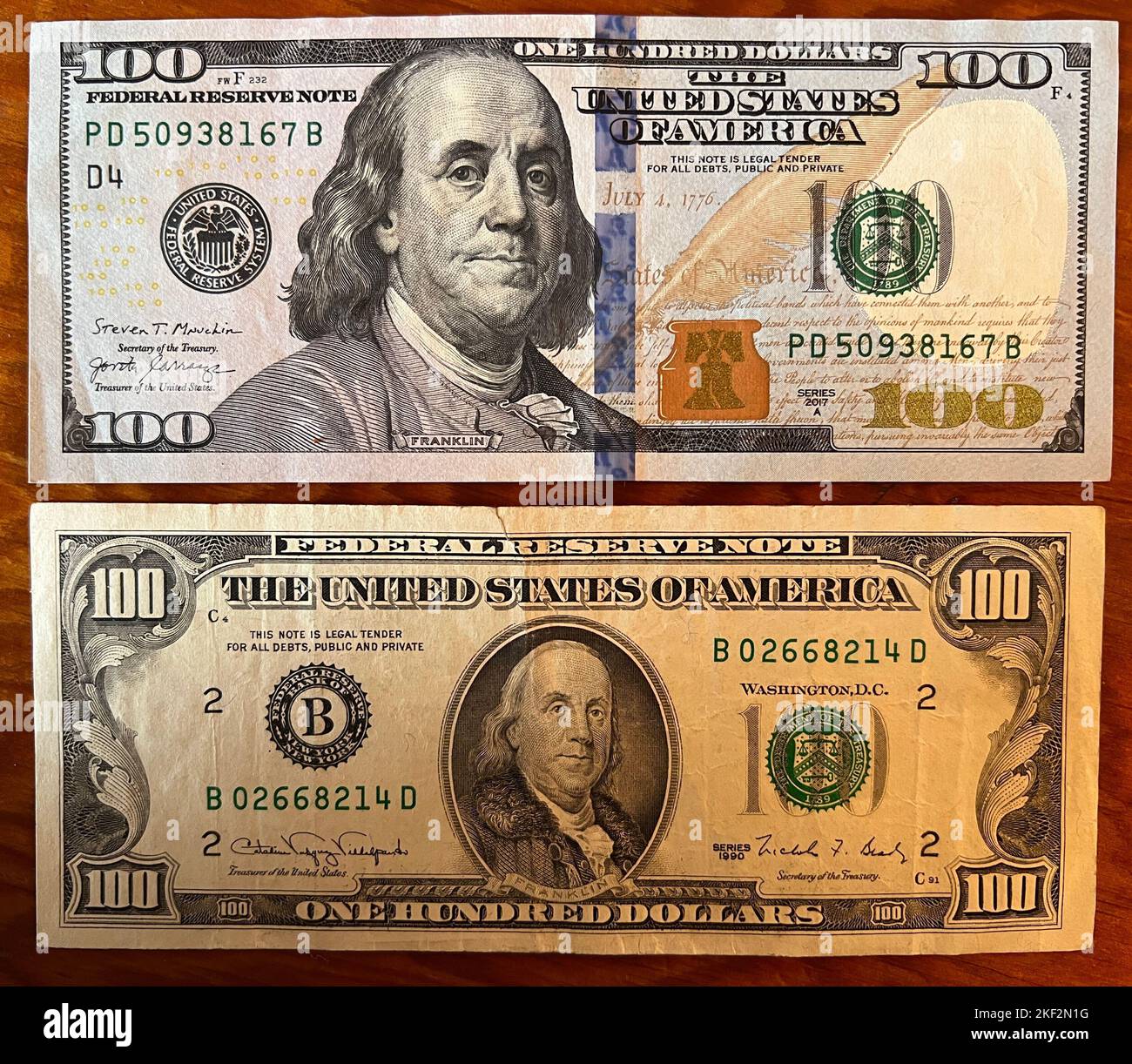 Older and newest $100 US bills both with Benjamin Franklin on its face ...