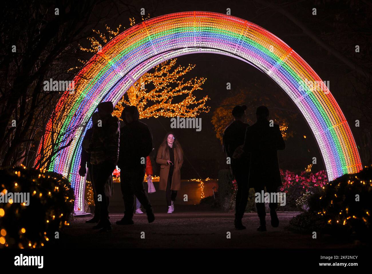 Warsaw, Poland. 15th Nov, 2022. Visitors walk through a rainbow light ...