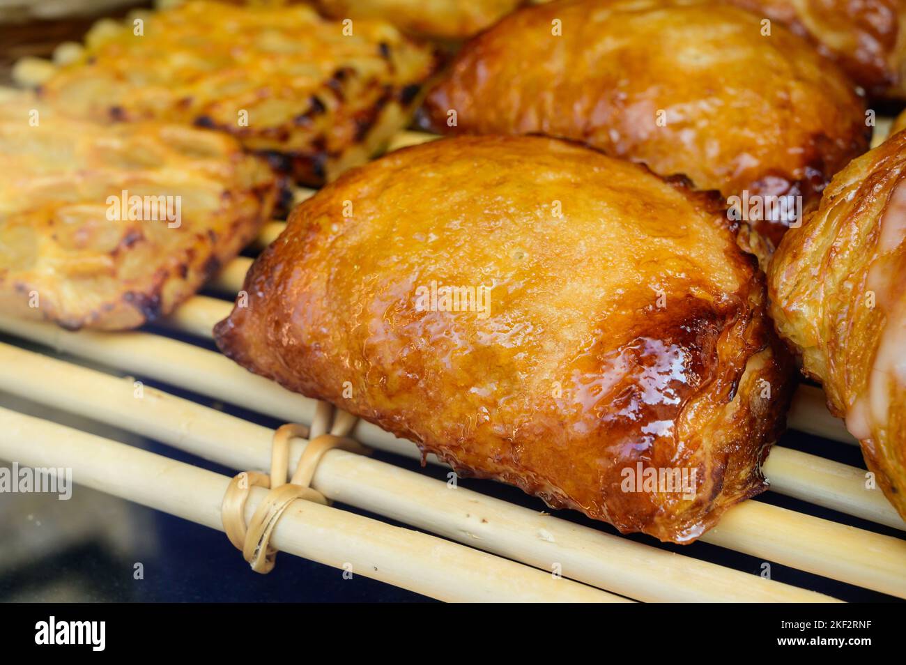 French bakery, fresh baked sweet buns and rolls on display in small ...