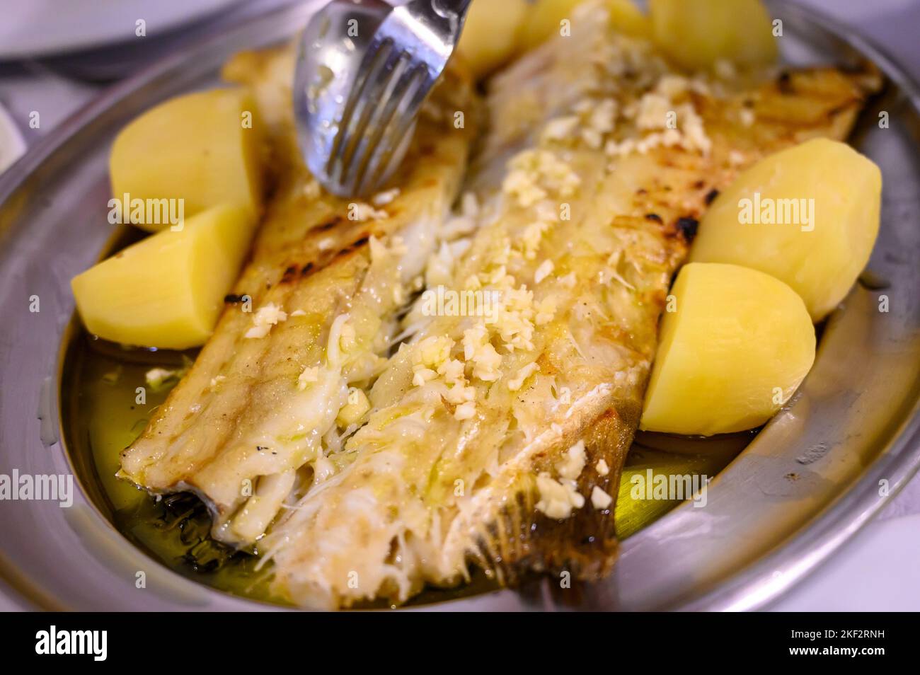 Grilled fillet of white codfish bacalhau served with potatos in fish ...