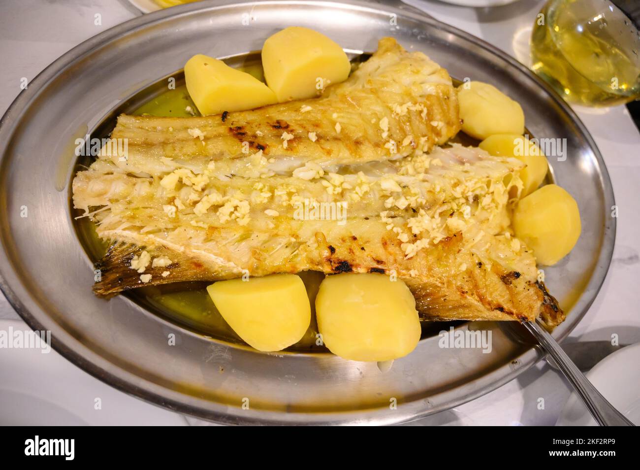 Grilled fillet of white codfish bacalhau served with potatos in fish ...