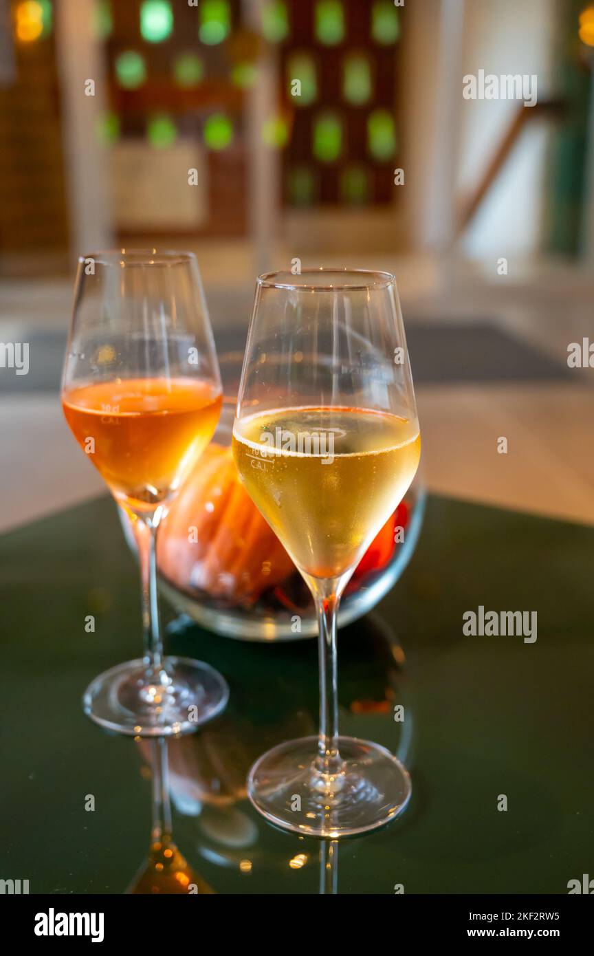 Tasting of brut and rose champagne sparkling wine produced by traditional method in underground ...