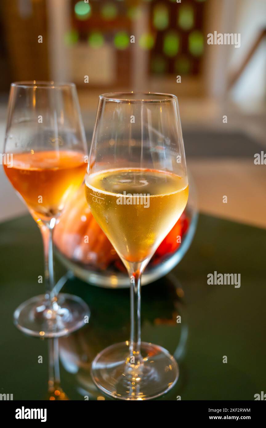 Tasting of brut and rose champagne sparkling wine produced by traditional method in underground ...