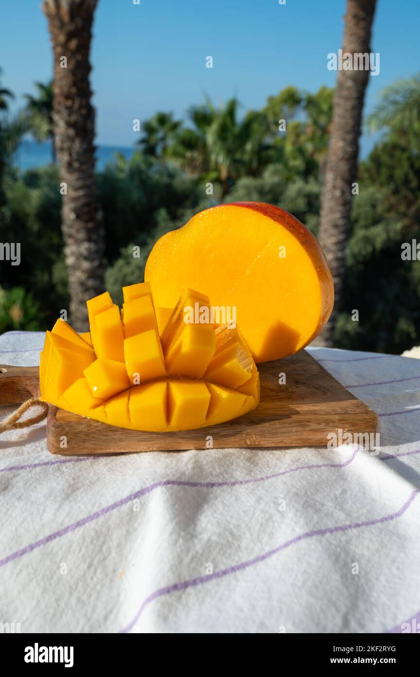 Fresh ripe sweet yellow mango tropical fruit served outdoor with view ...