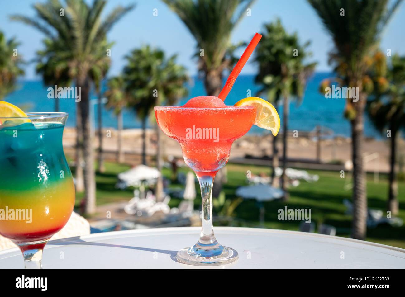 Colourful cold Strawberry daiquiri and Rainbow Paradise cocktails ...