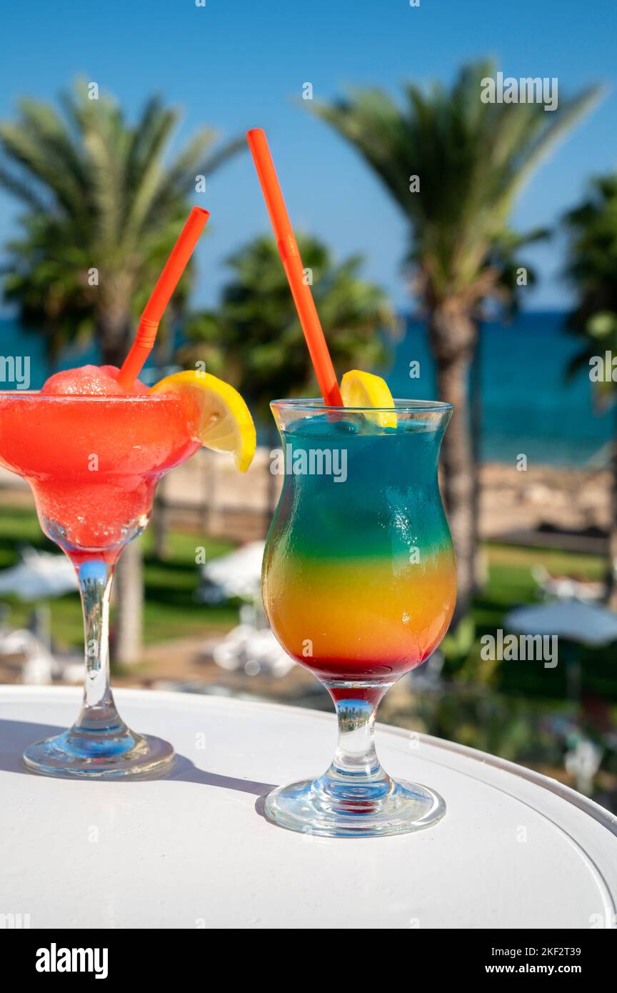 Colourful cold Strawberry daiquiri and Rainbow Paradise cocktails ...