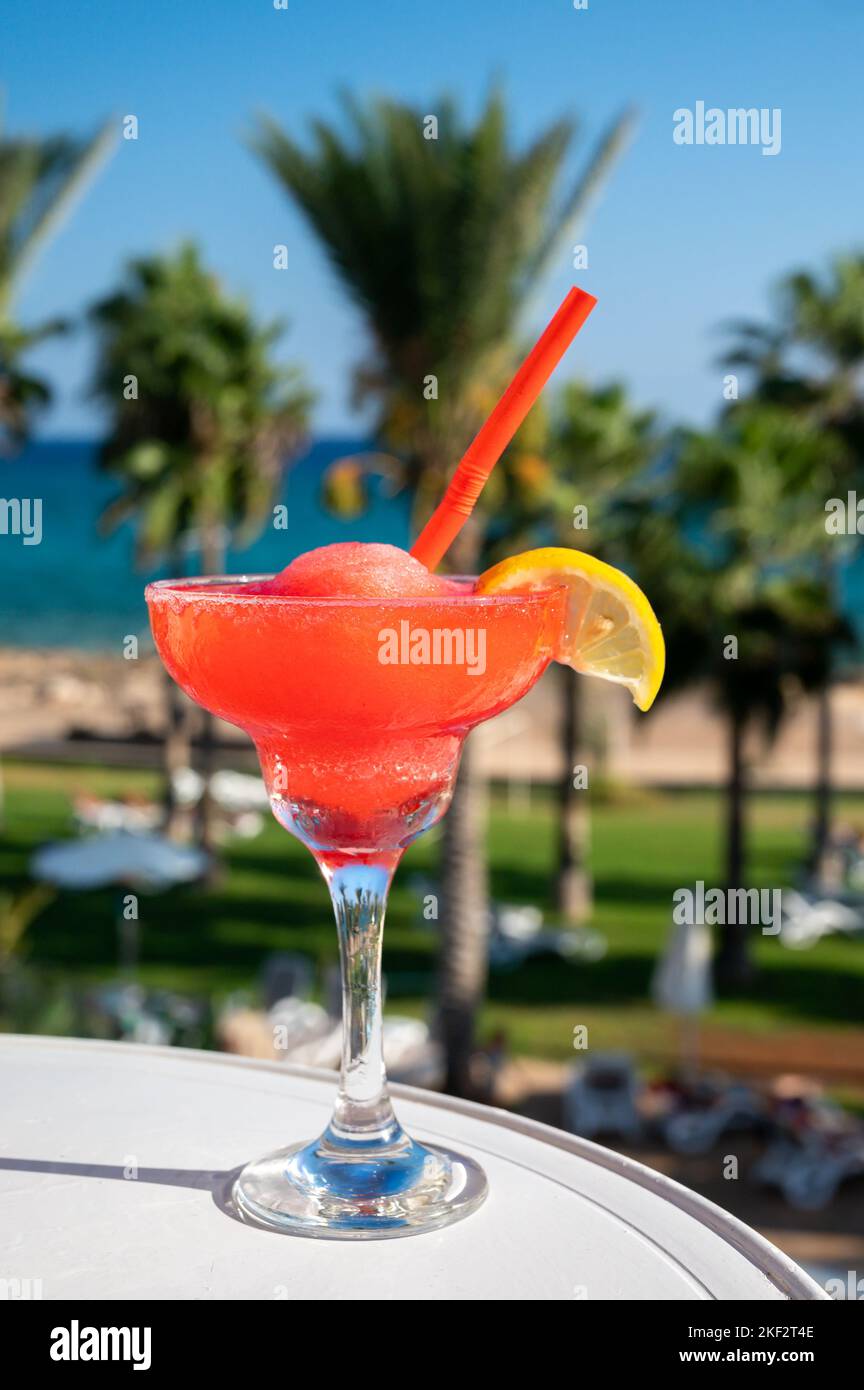 Colourful frozen pink Strawberry daiquiri cocktail drink served in ...