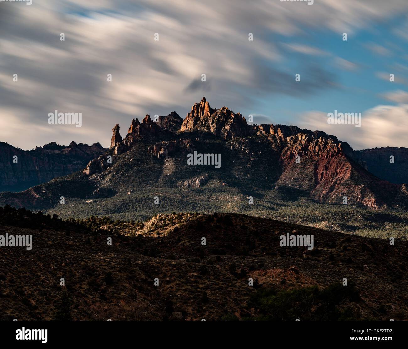 A red rocky canyon with golden sunset background Stock Photo - Alamy