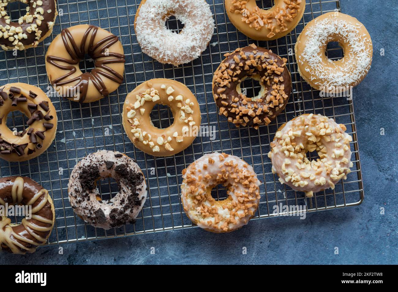 An above view of a cooling rack with glazed donuts and assorted ...