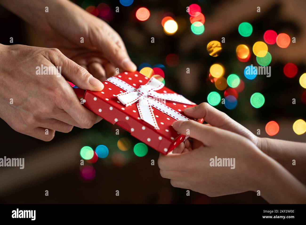 Christmas gift giving between parent and child Stock Photo - Alamy