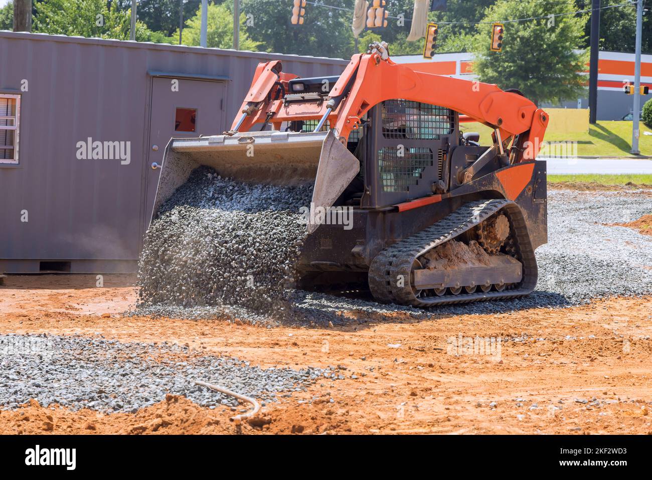 Excavator at construction site mini loader bobcat transports crushed ...
