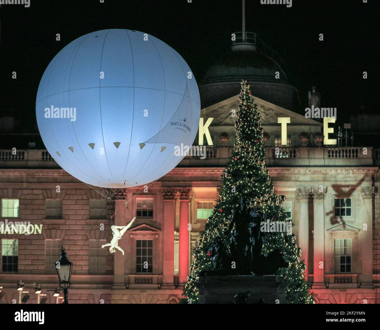 London, UK. 15th Nov, 2022. A large balloon and acrobat performer hang ...