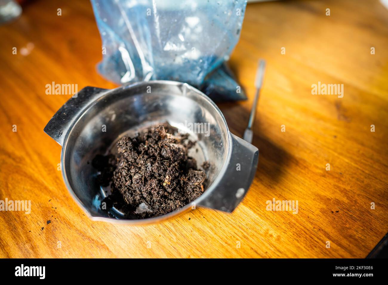 conducting a soil test in a home lab. soil on a table. brown dirt in a ...