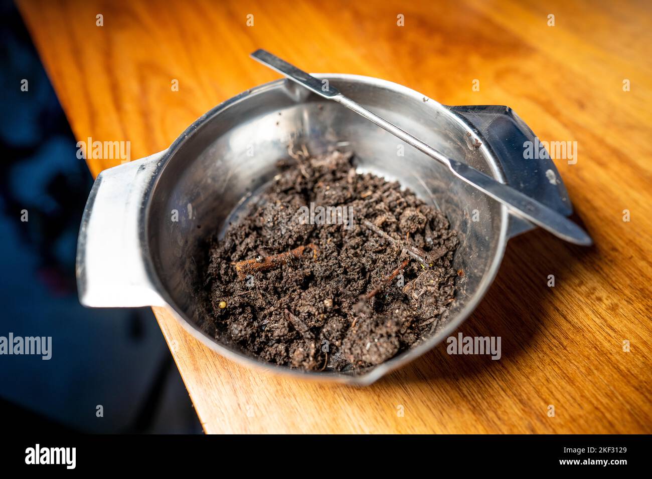 conducting a soil test in a home lab. soil on a table. brown dirt in a ...