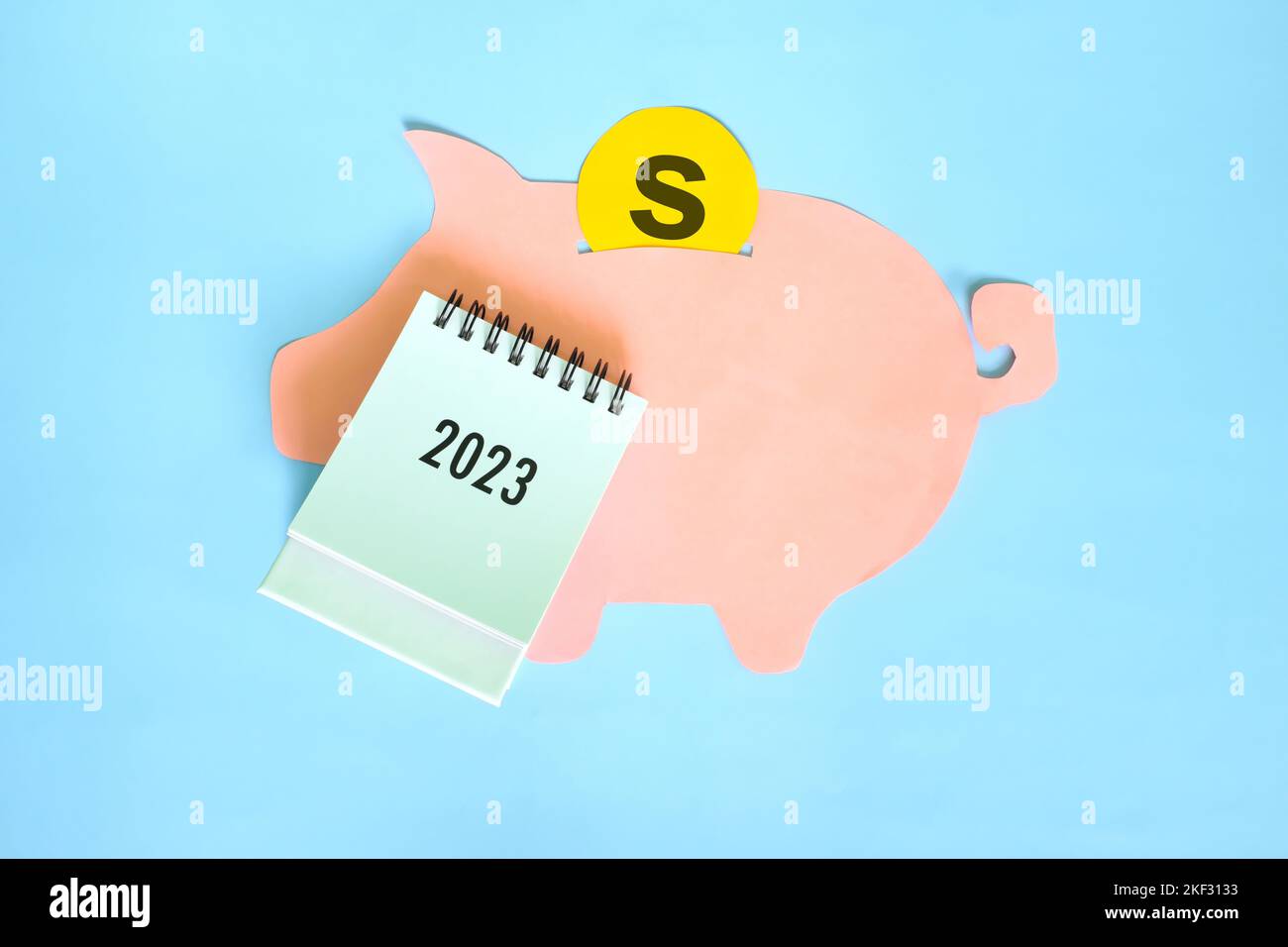 New year 2023 start saving resolution concept. Desk calendar with piggy ...