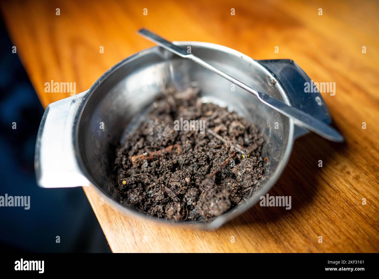 conducting a soil test in a home lab. soil on a table. brown dirt in a ...