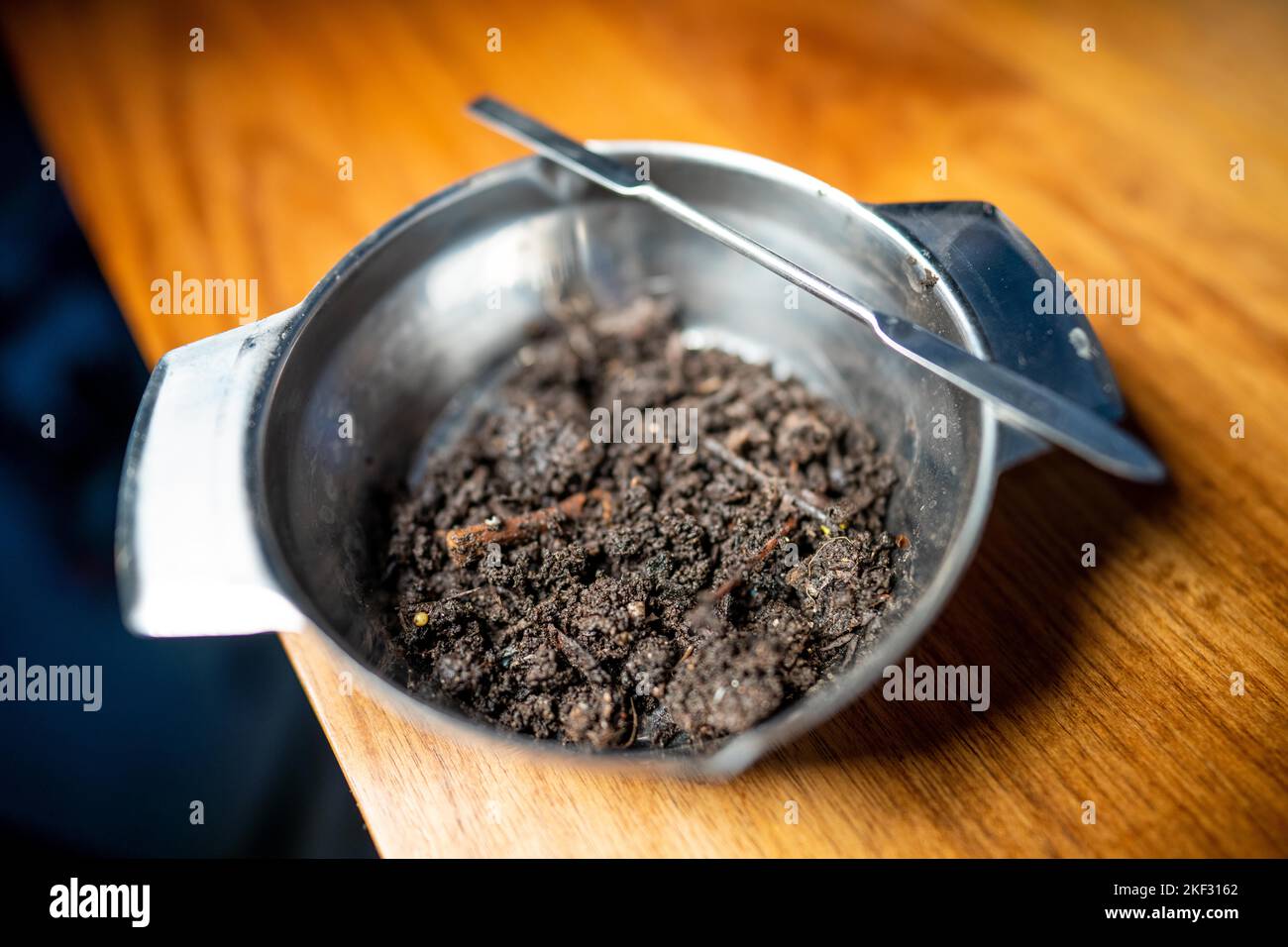 conducting a soil test in a home lab. soil on a table. brown dirt in a ...