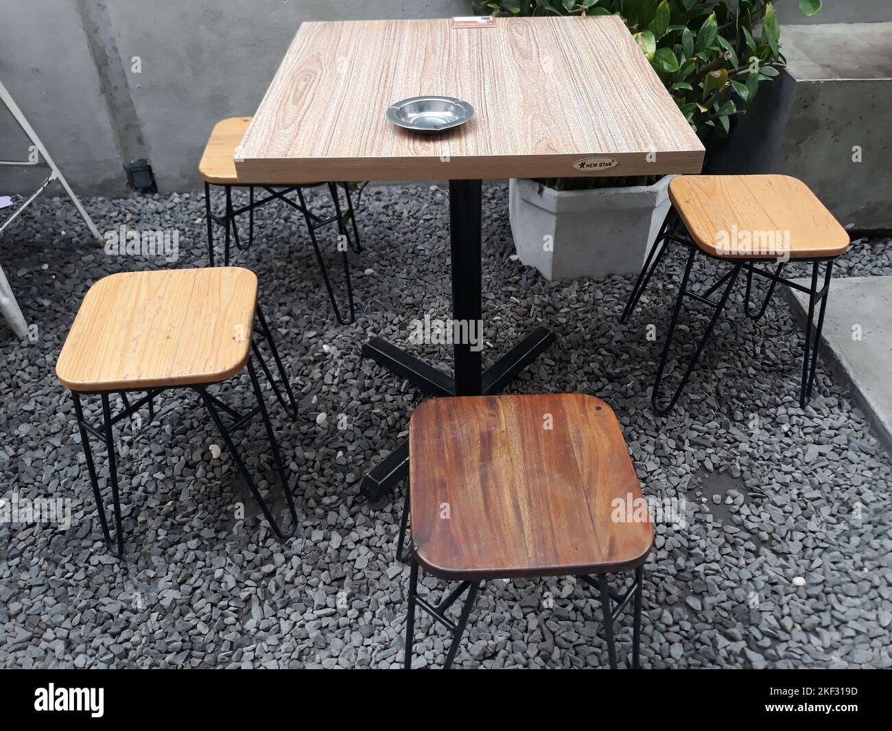 Design Interior a café table and chairs with stone floors and plant ...
