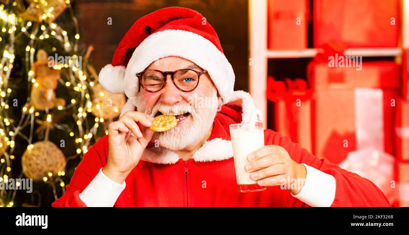 Santa make funny face and picking cookie. Mature Santa eating cookie ...