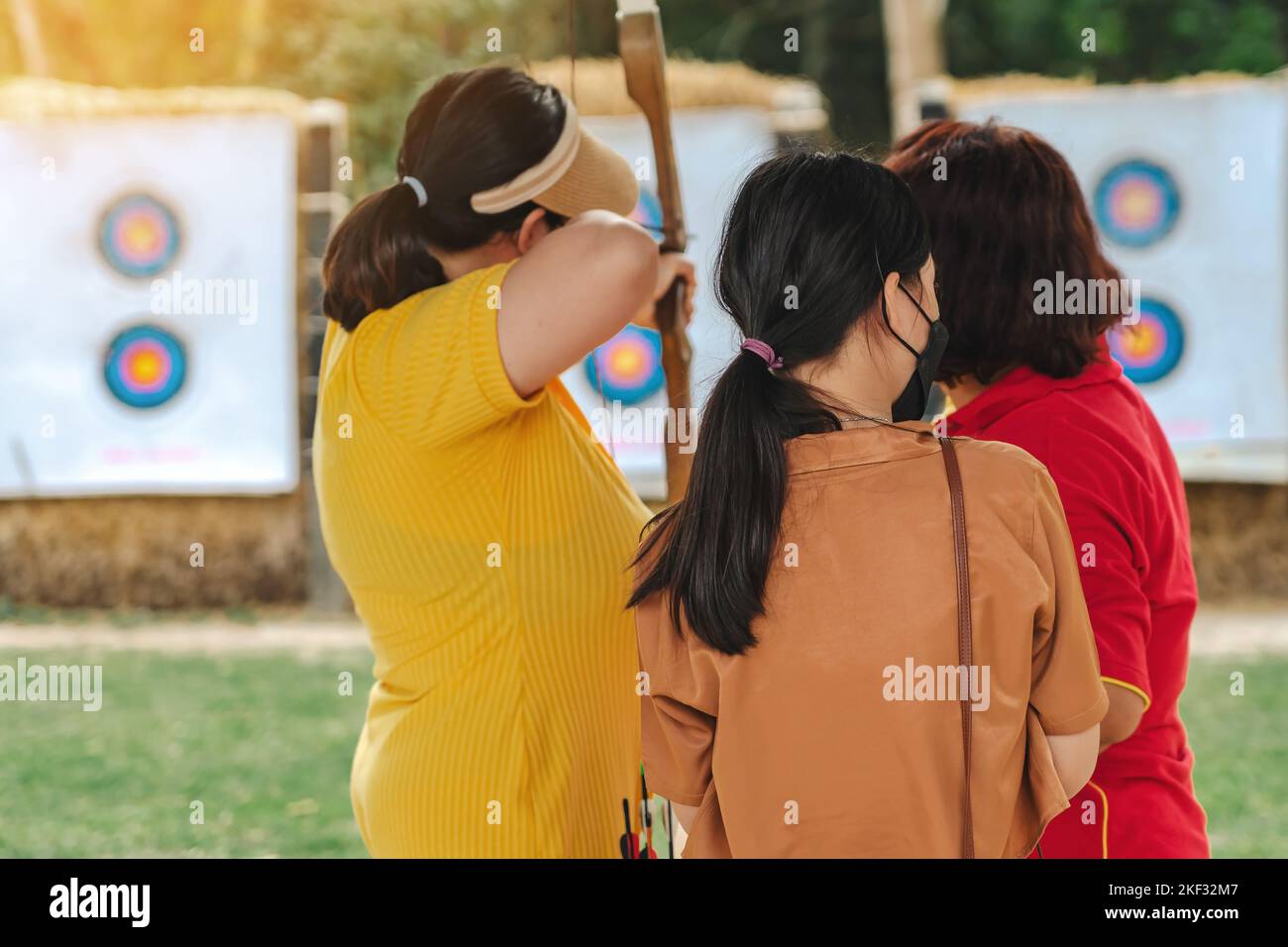 Back view of daughter wear face mask cheering and taking pictures for ...