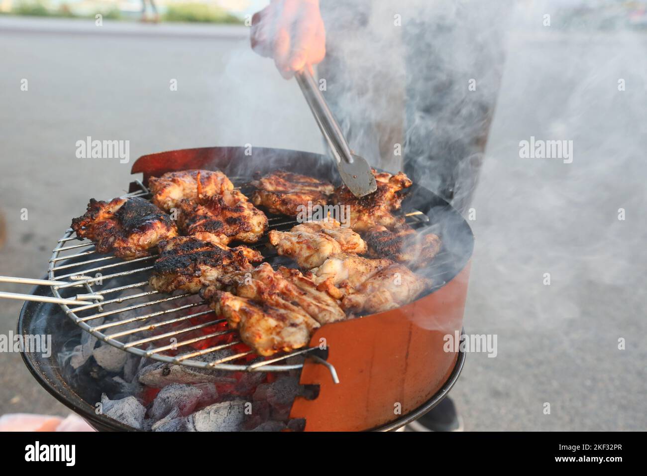 Cooking chicken chops at the barbecue party Stock Photo - Alamy