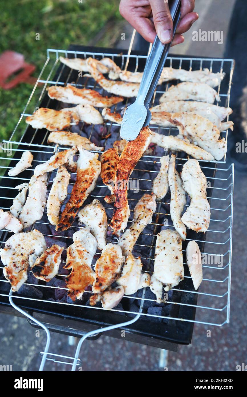 Cooking chicken fillets at the barbecue party Stock Photo - Alamy