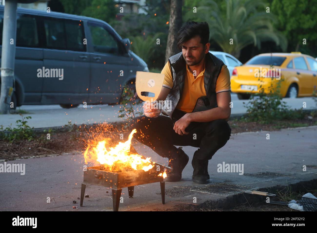 ISTANBUL, TURKEY - SEPTEMBER 7: Turkish man is having a barbecue by the ...