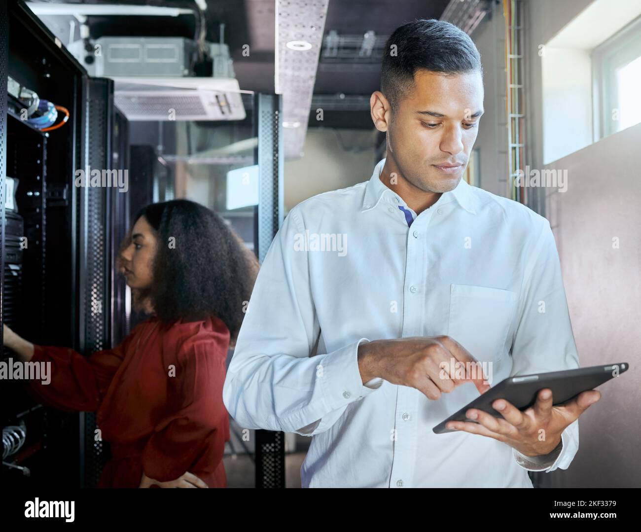 Management, server room and tablet with business people in data center ...